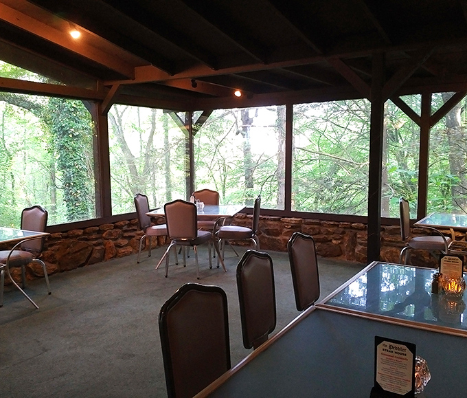The screened porch dining area brings the outdoors in, offering forest views that pair perfectly with whatever's on your plate.
