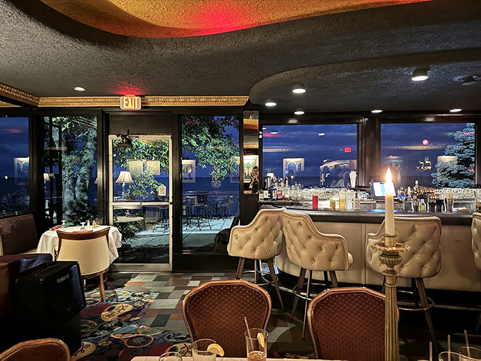 As evening falls, HOBNOB's interior glows with possibility&mdash;white tablecloths, leather chairs, and windows framing the twilight lake view.