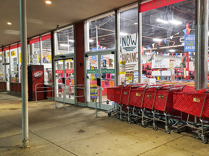 Red shopping carts await their mission outside Ollie's entrance, ready to be filled with treasures that won't empty your bank account.