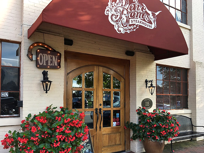 The welcoming entrance, flanked by vibrant flowers, offers a first impression that says, "Yes, you've made an excellent decision coming here tonight."