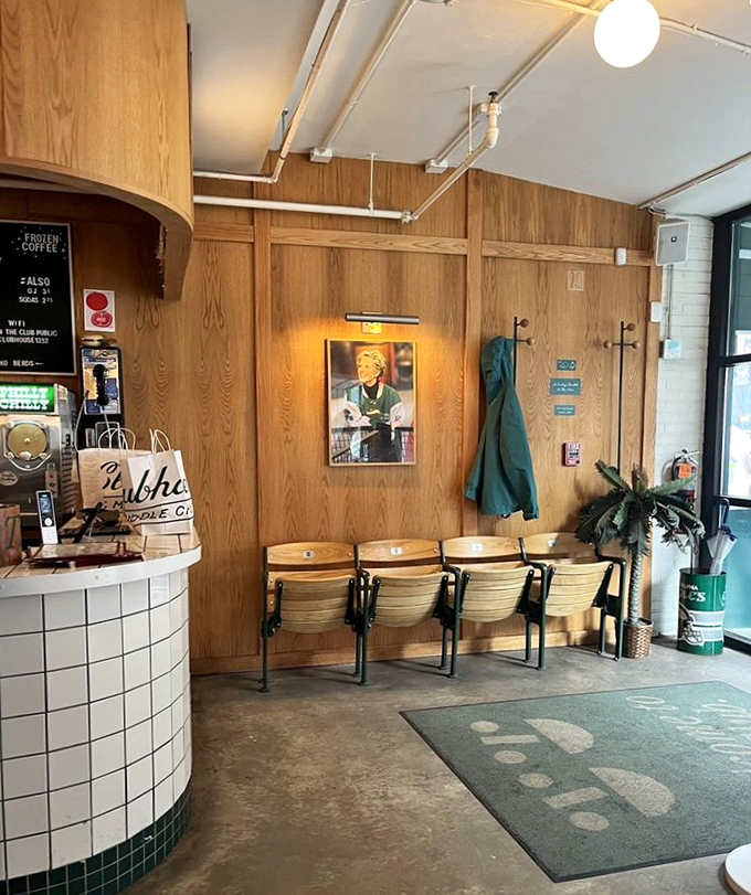 Vintage theater seats create the world's most stylish waiting area, proving even standing by for a table can be an experience.