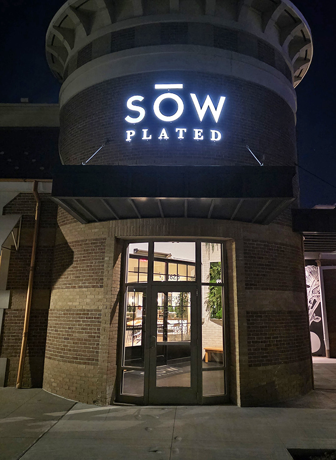 Evening lighting transforms the distinctive brick exterior into a beacon for food lovers across Columbus.