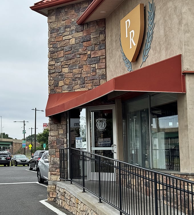The gateway to gastronomy. Penrose's stone facade and PR shield logo stand as a promise of consistent quality that's kept customers returning for generations.