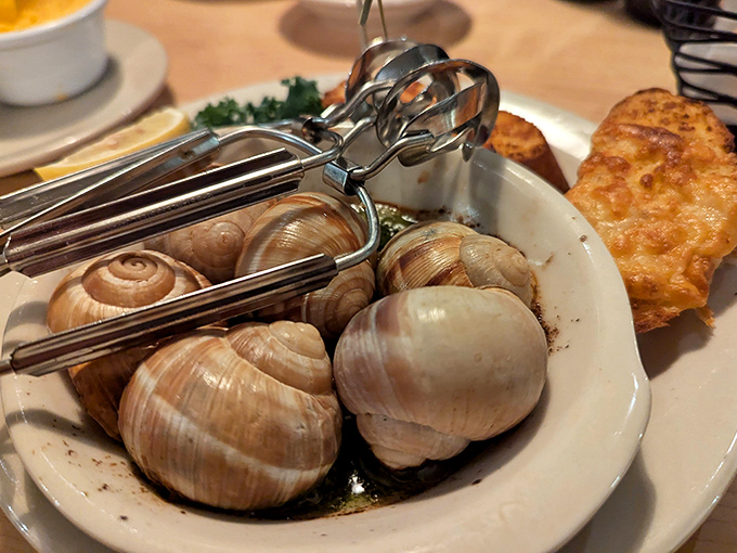 Escargot that proves sometimes the best things in life come with special tools and garlic butter. That cheese toast is the perfect sopping companion.