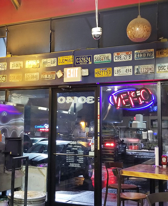 The license plate collection above the exit tells stories of barbecue pilgrimages from across America. Good 'cue creates its own community.