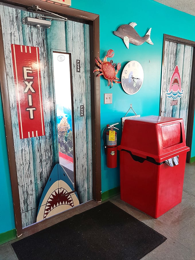 The exit door comes with its own shark guardian. It's saying, "You can leave, but you'll be back when that seafood craving hits again."