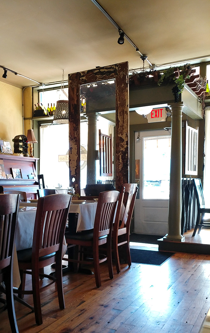 Weathered wooden frames and columns create doorways between dining areas, like chapters in a delicious story you never want to end.