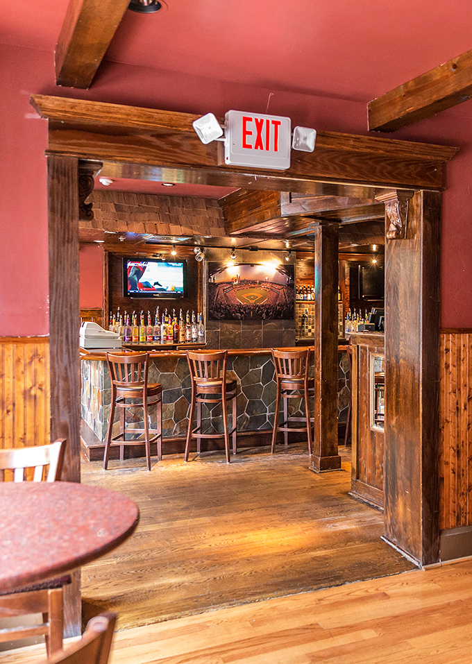 Wooden beams and warm lighting create passages between dining areas that feel like you're discovering new rooms in a particularly delicious treasure hunt.