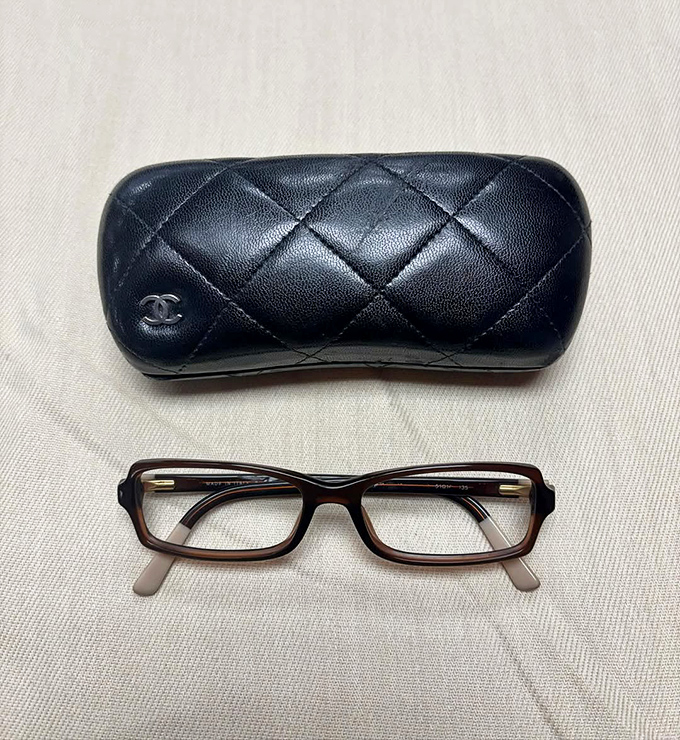 Chanel eyeglass case sitting quietly, containing both practical vision correction and the subtle flex of luxury that cost less than a fancy dinner.