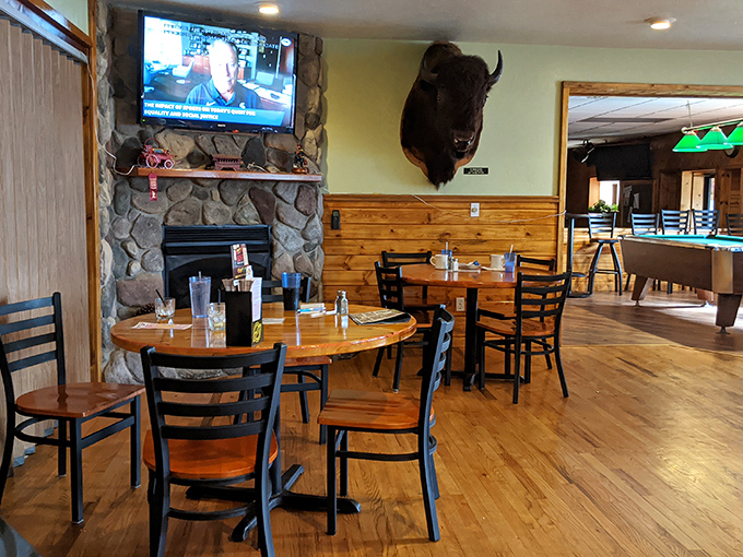 A stone fireplace anchored by a watchful buffalo head creates the quintessential Up North atmosphere that makes winter meals even more satisfying.