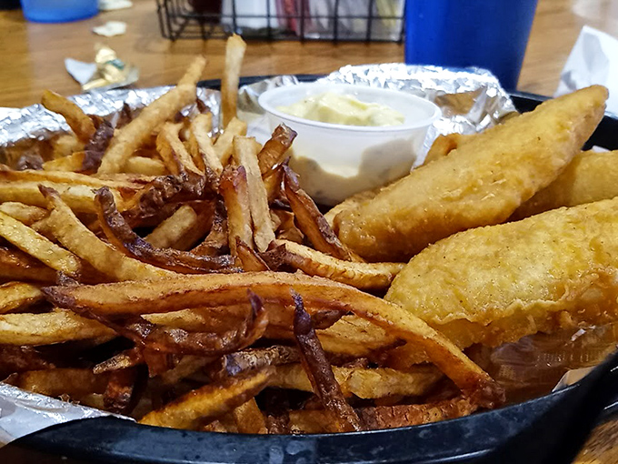 Fish so crispy it practically shatters, fries that could start arguments over who gets the last one. This basket demands both hands and your full attention.