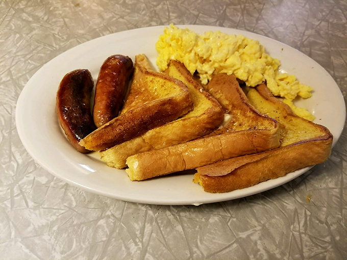 French toast that achieves the golden ratio of crispy exterior to custardy interior, paired with sausages that snap with each bite.