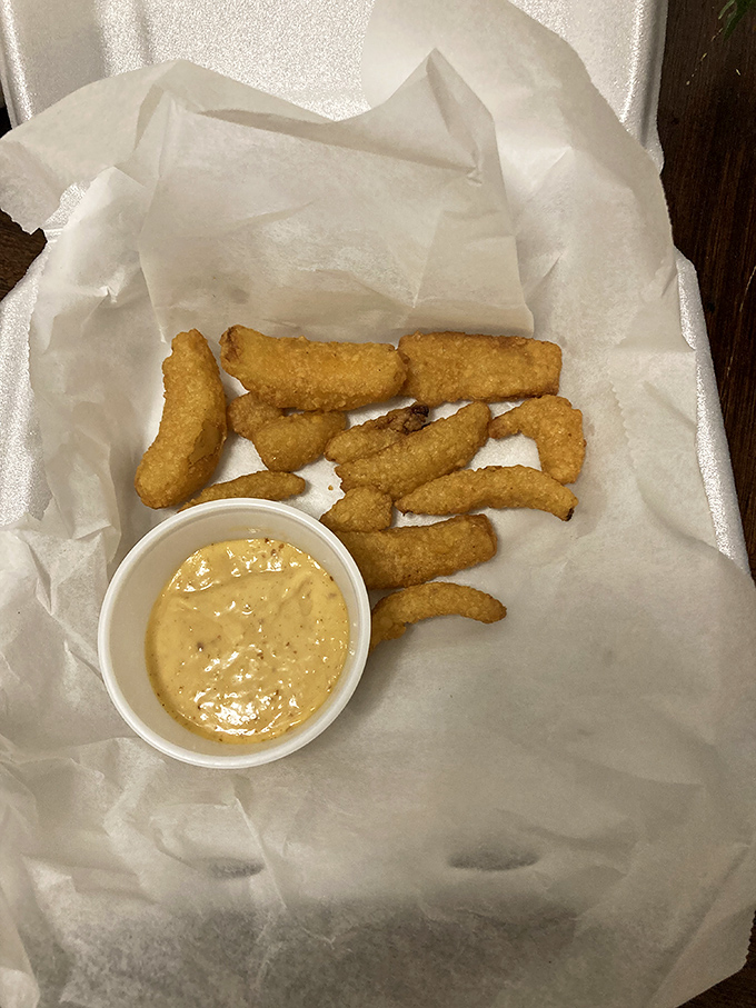 Golden-fried pickle spears with a side of creamy sauce—the unexpected appetizer that has everyone at the table saying, "Order another round."