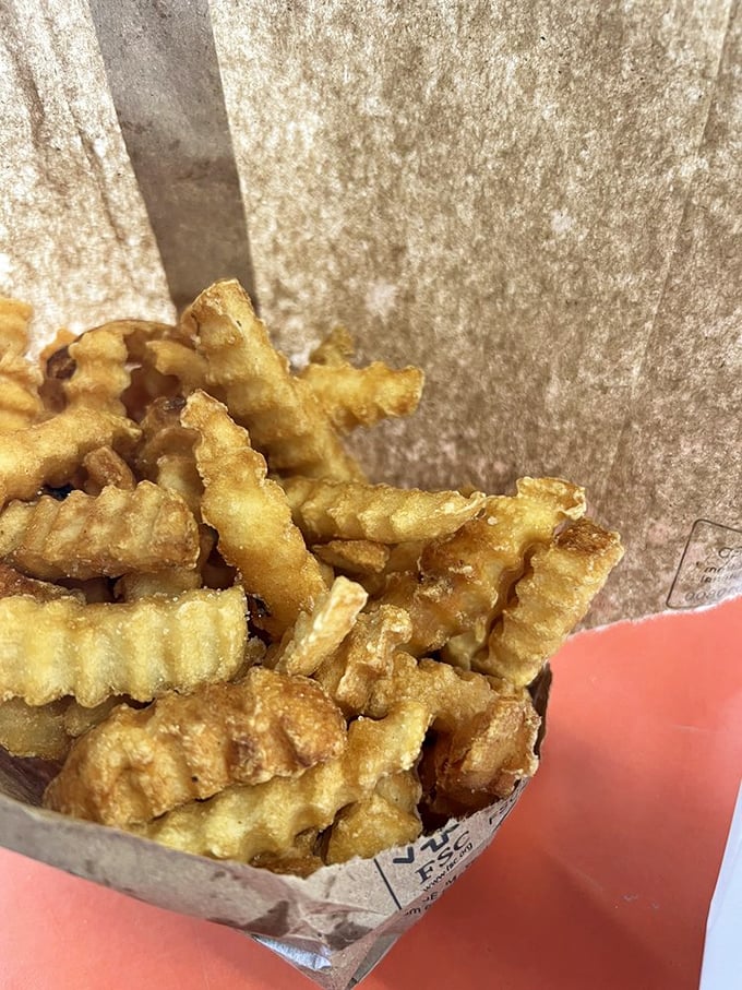 Crinkle-cut fries that achieve the perfect balance between crispy exterior and fluffy interior. Each ridged edge captures just the right amount of salt.