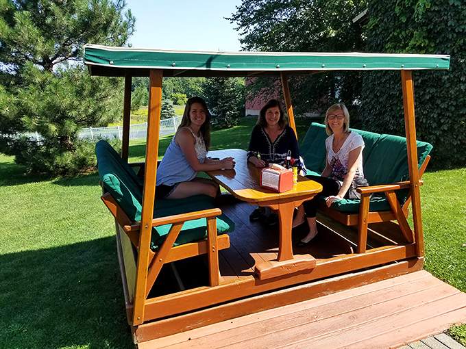The glider dining experience&mdash;where gentle swinging meets serious eating. Somehow food tastes better when you're gently rocking in the Michigan breeze.