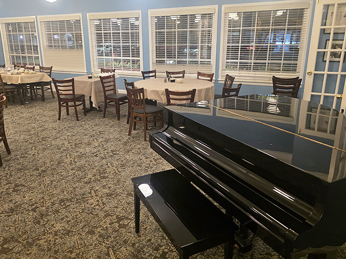 A grand piano waits silently in the corner, promising musical accompaniment to match the symphony of flavors in the dining room.