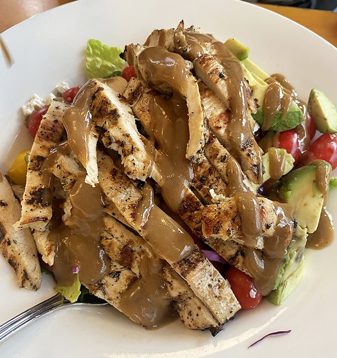 A grilled chicken salad that somehow makes eating greens feel like an indulgence rather than a compromise. That balsamic glaze is practically liquid gold.