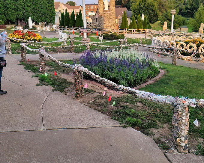 The grotto grounds blend flowers and stonework in perfect harmony&mdash;like someone decided conventional landscaping needed more pizzazz.