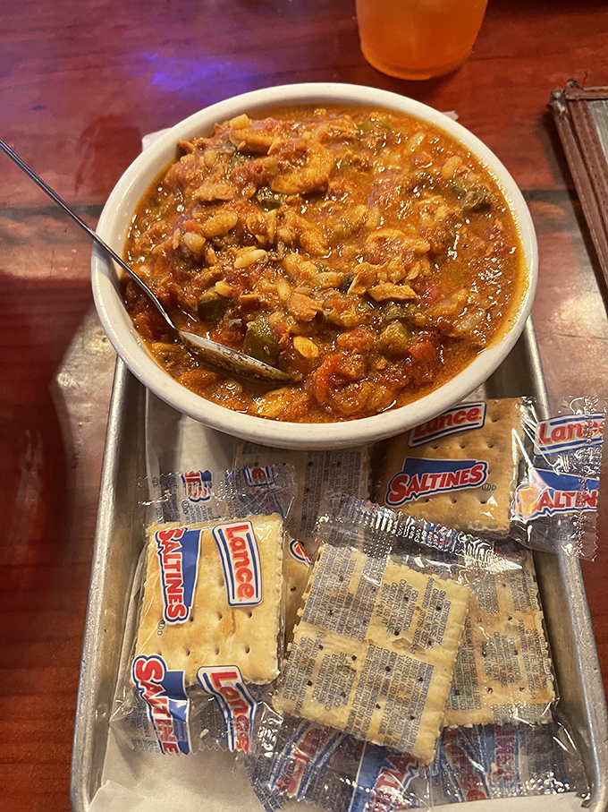 Gumbo served with a flotilla of saltines—a bowl of coastal comfort that warms you from the inside out. Spoons up, napkins ready!