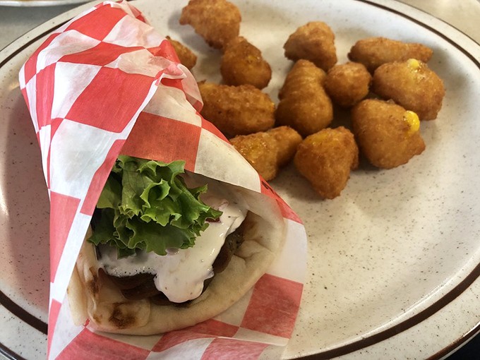 Wrapped and ready for lunchtime glory. This gyro with crispy tater tots on the side proves the diner's menu extends well beyond breakfast favorites.