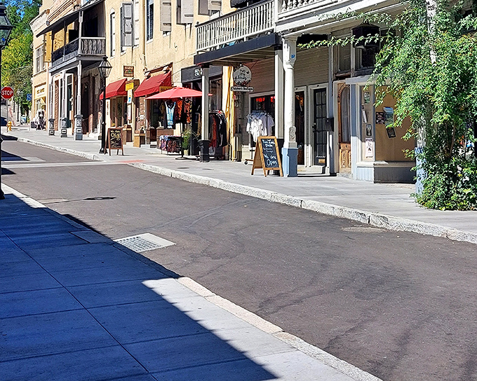 Awnings create pools of shade along the historic storefronts, inviting window-shoppers to linger a little longer on sun-drenched afternoons.