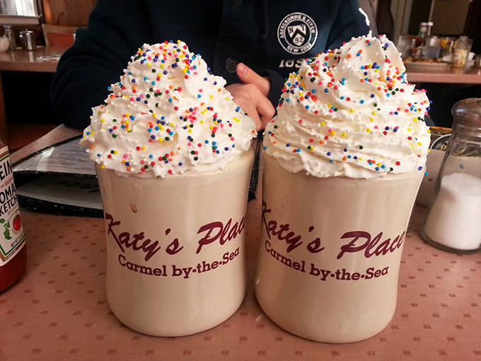 These festive hot chocolate mountains topped with whipped cream and sprinkles aren't just drinks&mdash;they're childhood nostalgia in ceramic form.