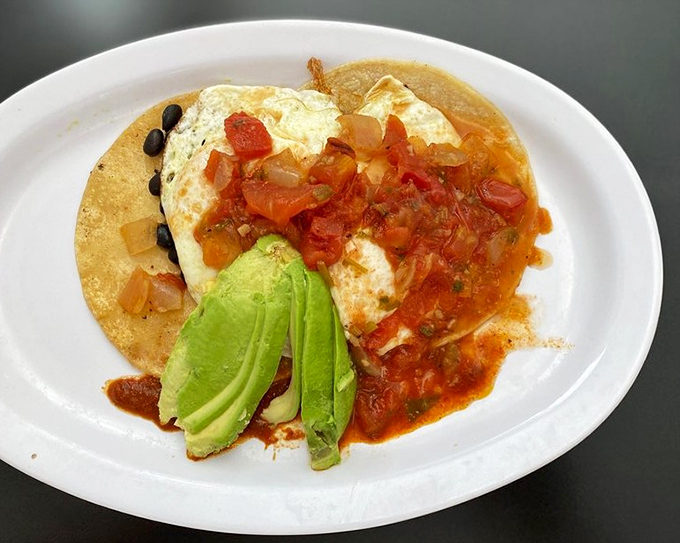 Huevos with avocado and salsa &ndash; proof that breakfast knows no borders and tastes better with a splash of color.