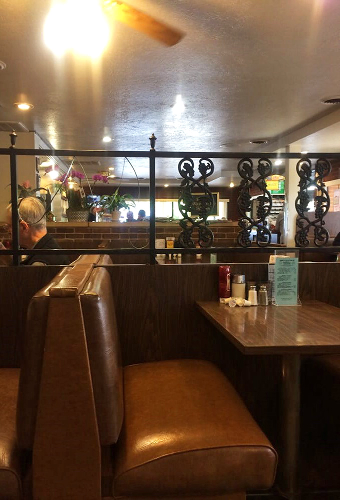 Ornate dividers between booths add unexpected character - like finding out your no-nonsense uncle secretly collects vintage vinyl.