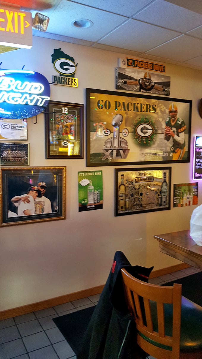 The wall of Packers memorabilia serves as both decoration and Wisconsin citizenship test – true locals can name every player pictured.