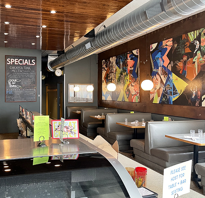Colorful artwork and cozy booths create the perfect backdrop for comfort food consumption. The specials board promises new adventures with each visit.