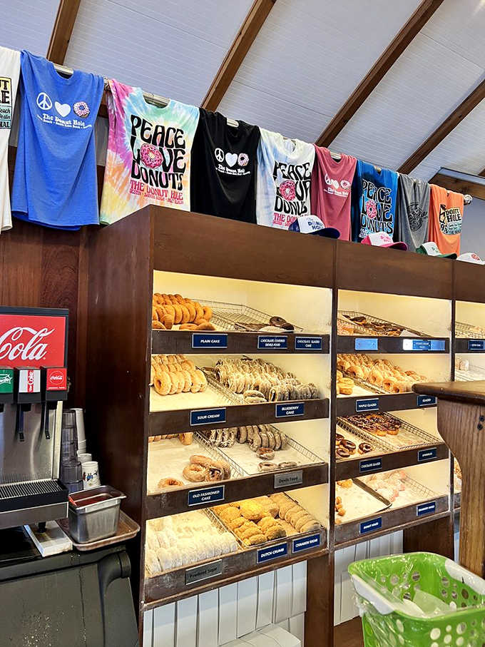 Peace, love, and donuts&mdash;the holy trinity of happiness. Those colorful shirts hanging above fresh-baked treasures perfectly capture the Donut Hole philosophy.