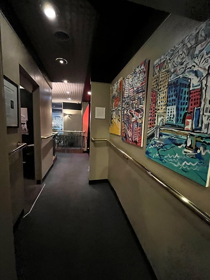 The hallway gallery showcases local art, turning even a trip to the restroom into a cultural experience.