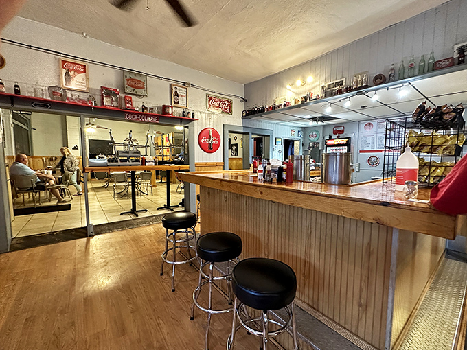 The counter where magic happens&mdash;simple ingredients transformed into memorable meals under the watchful gaze of vintage Coca-Cola signs.