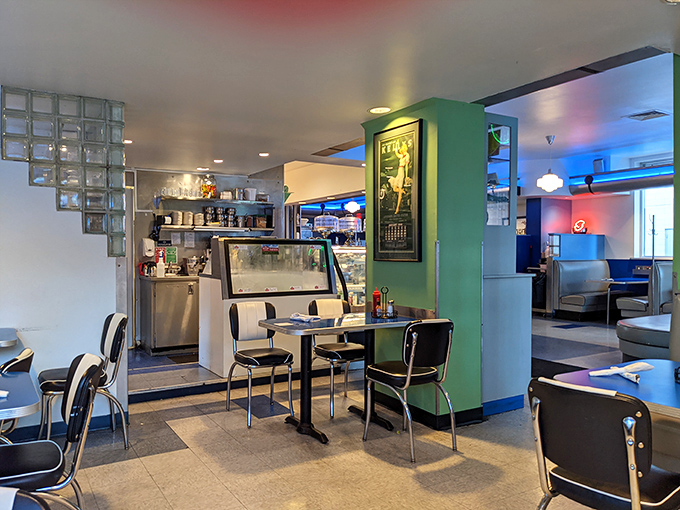 Retro meets modern in this thoughtfully designed space. The glass block dividers and mint green accents create distinct dining zones without sacrificing the communal vibe.