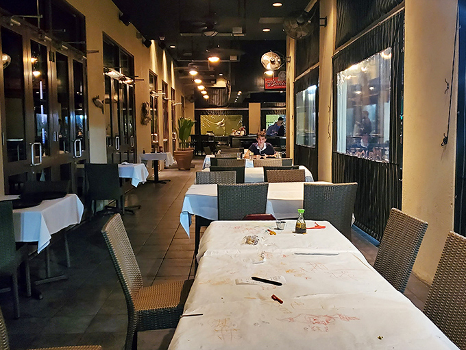 The outdoor dining area offers a quieter alternative for those important conversations about whether to order dessert (the answer is always yes).