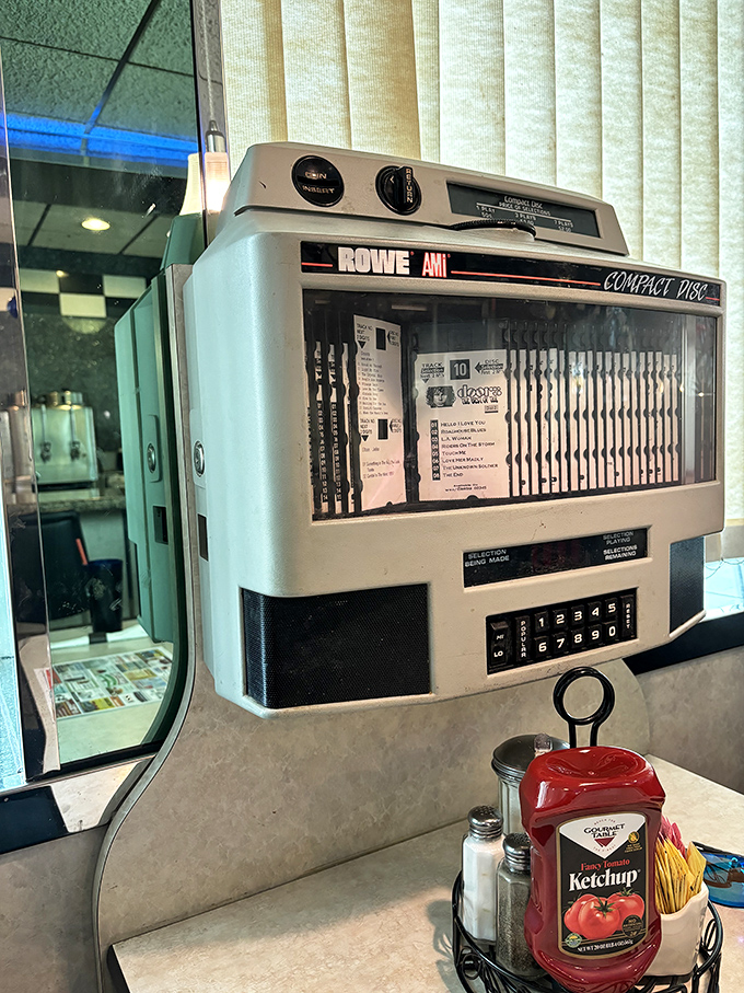 The vintage jukebox stands guard like a time-traveling sentinel, ready to provide the soundtrack to your meal with hits from simpler times.