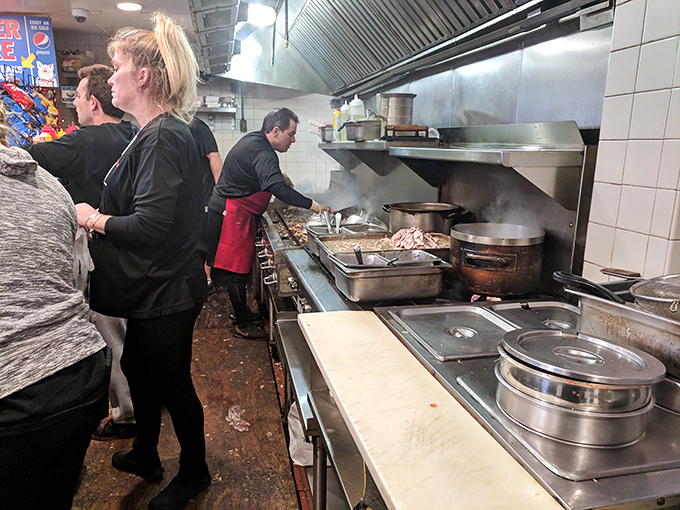 Where the magic happens—skilled hands working with practiced precision to transform simple ingredients into legendary sandwiches right before your eyes.