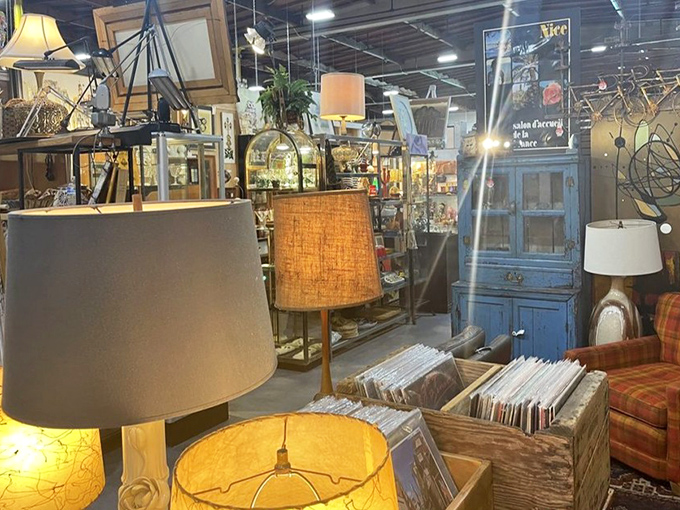 A forest of lampshades casts a warm glow over crates of vinyl records. The perfect corner for both audiophiles and design lovers.