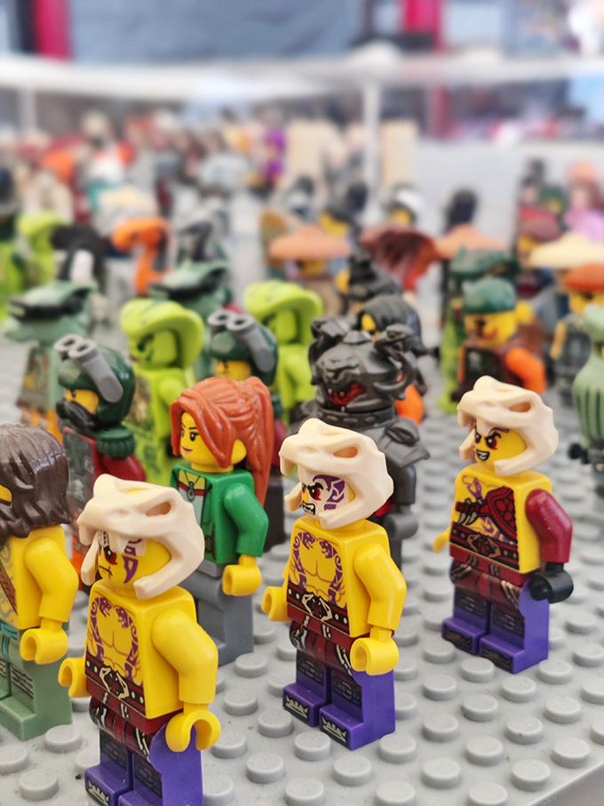 Tiny plastic warriors standing at attention, ready for new adventures. These LEGO minifigures prove that imagination comes in small packages with interchangeable heads.