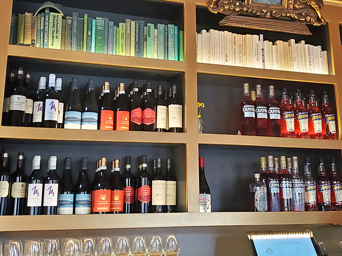 Color-coordinated bottles line the shelves like delicious soldiers standing at attention, ready to enhance your dining experience one sip at a time.
