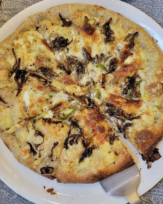 A mushroom pizza that makes you question why you ever ordered pepperoni. Earthy, cheesy, and worth every carb-laden bite.
