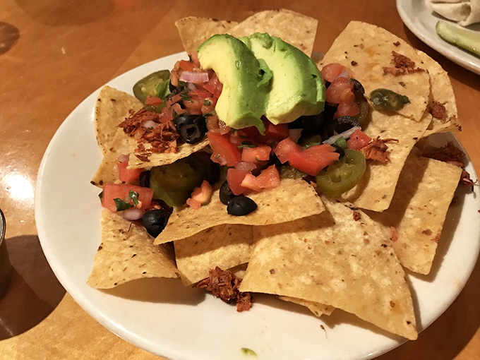 Nachos arranged with surgical precision&mdash;each chip a potential vehicle for the perfect bite of avocado, jalape&ntilde;o, and fresh pico de gallo.