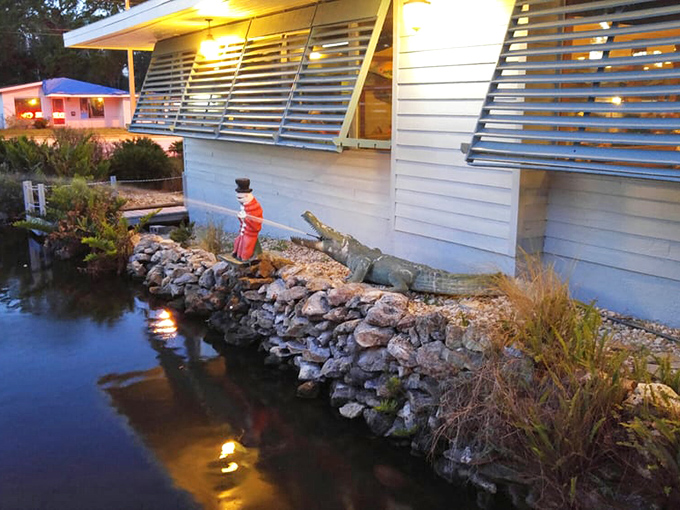 Even at night, the charming pond adds waterfront ambiance &ndash; complete with a dapper alligator statue dressed for dinner.
