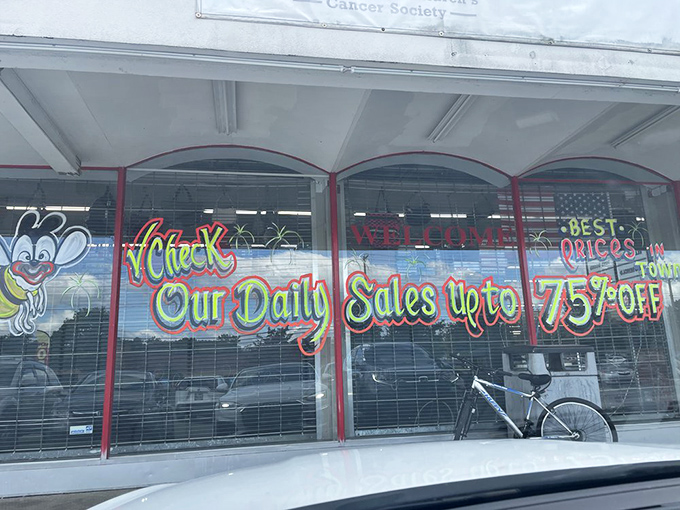 Window signage promising discounts up to 75% off&mdash;the siren song of thrift stores that turns casual browsers into dedicated treasure hunters.