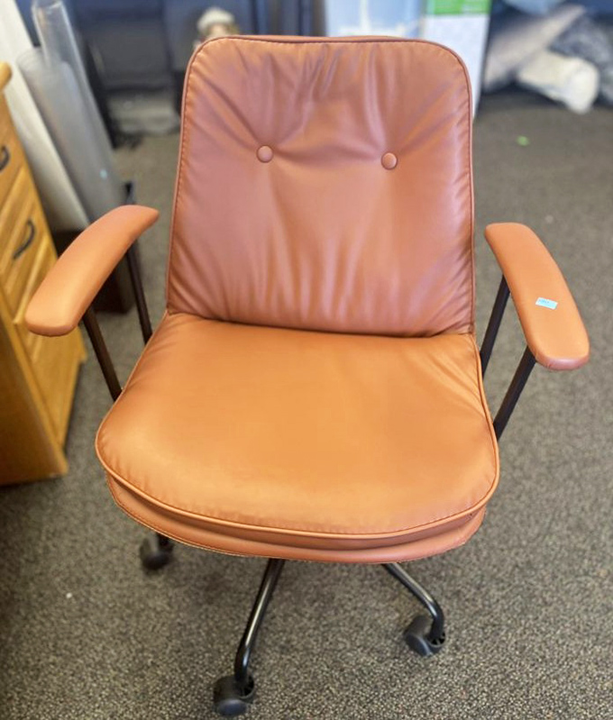 This burnt-orange office chair isn't just seating—it's a 1970s executive power move on wheels. Don Draper would nod approvingly at your thrifty style.