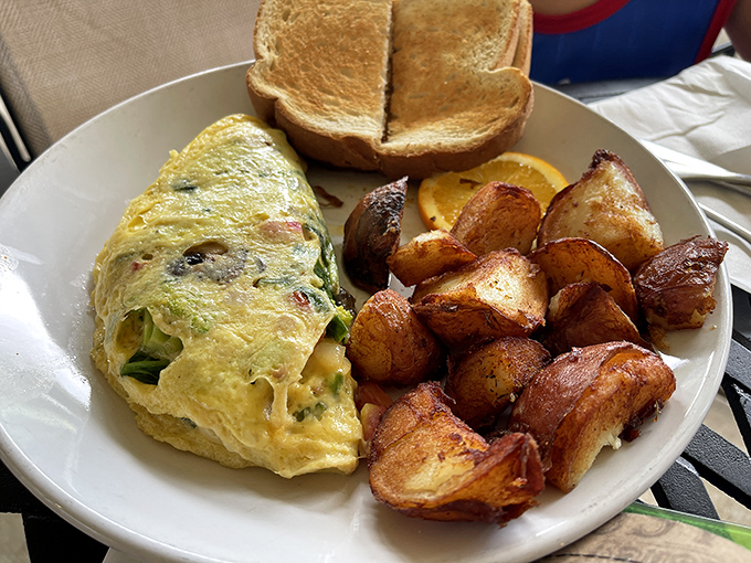 A fluffy omelet that's had a proper education in flavor. Those home fries on the side look like they've been roasted by angels.