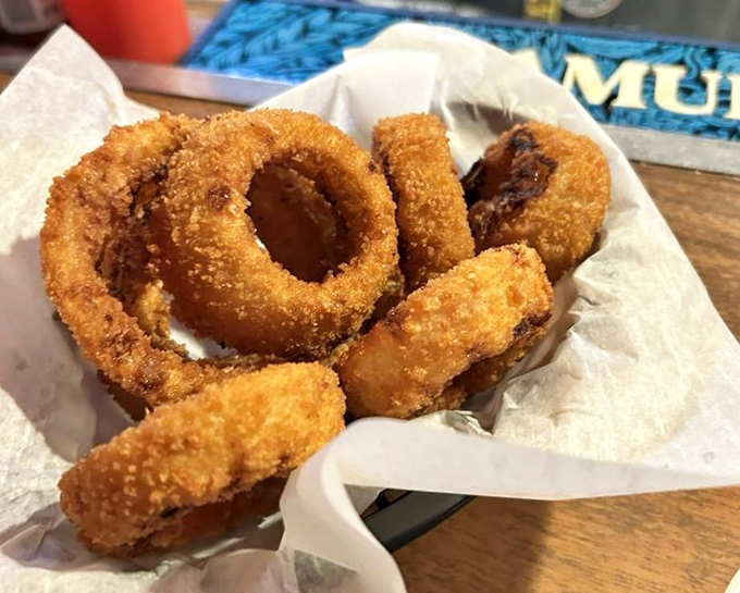 Onion rings with the perfect crunch-to-softness ratio &ndash; the unsung heroes of the appetizer world, nestled in their paper-lined basket.