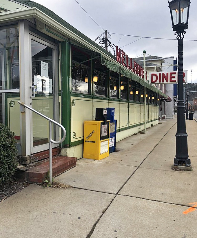 The diner's exterior view showcases its classic lines and vintage charm, with gas lamps nearby hinting at Wellsboro's commitment to preserving its historic character.