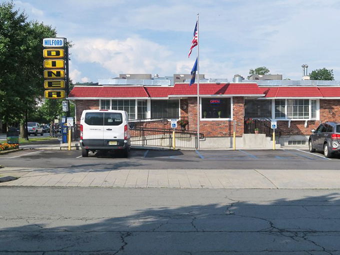 The American flag stands proud outside this temple of comfort food, where breakfast democracy means everyone gets exactly what they want.