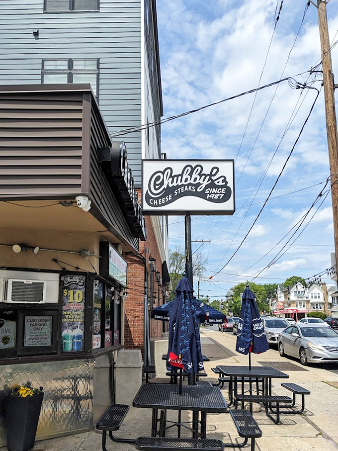 Outdoor seating under Labatt Blue umbrellas &ndash; because sometimes you need fresh air to fully appreciate the magnitude of the sandwich you're about to tackle.